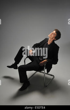 Full length of mysterious male model with face hidden under hood ...