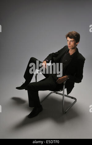 Full length of mysterious male model with face hidden under hood ...