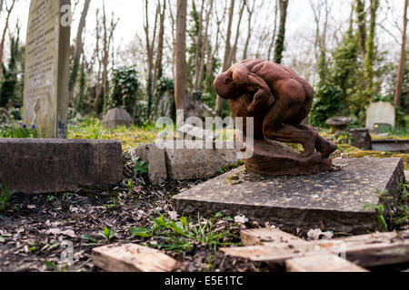Sculpture of a man pushing a boulder up hill like Sisyphus at Highgate ...