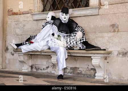 Commedia dell'arte style Harlequin jester couple walking in the ...