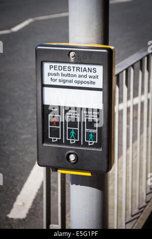 Pedestrian crossing push button to cross. Look left Stock Photo - Alamy