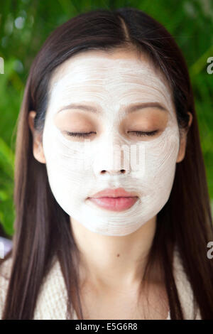 Woman with facial clay mask at spa salon or at home, skincare theme ...