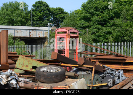 disused red telephone box amongst scrap metal at scrapyard leeds ...