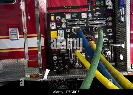 Hose connected to a fire truck at a house fire showing control panel ...