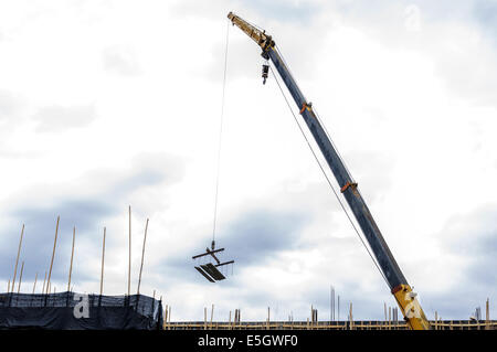 Crane hoist concrete plate at construction site Stock Photo - Alamy