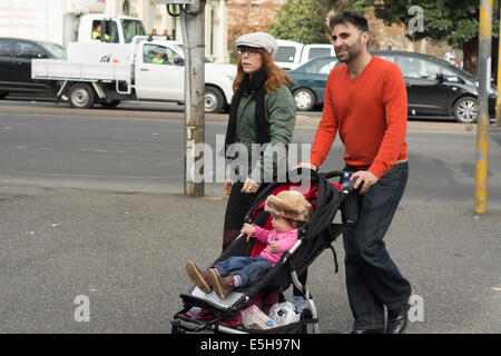 Family couple anxious father pushing pram Stock Photo - Alamy