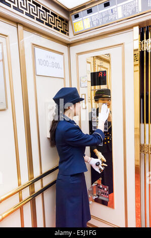 Lift operator in Takashimaya department store, Tokyo, Japan Stock Photo ...