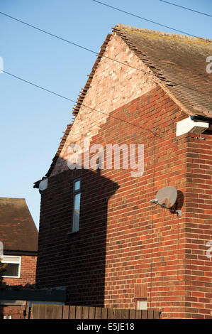 House Gable End bricks blown off storm windy ties Stock Photo - Alamy