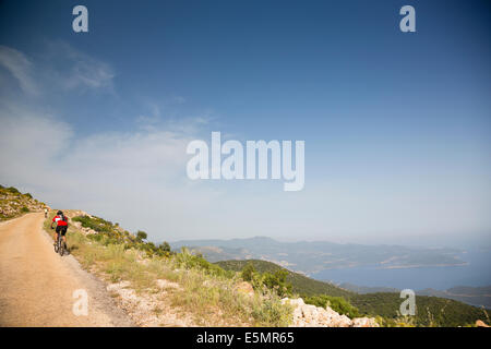 Exodus cycling clients climbing hill Stock Photo - Alamy
