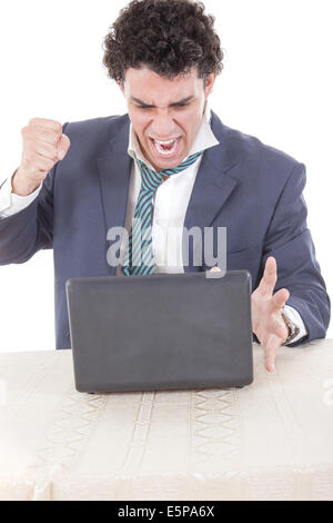 Frustrated young man hitting computer monitor keyboard with hammer at ...