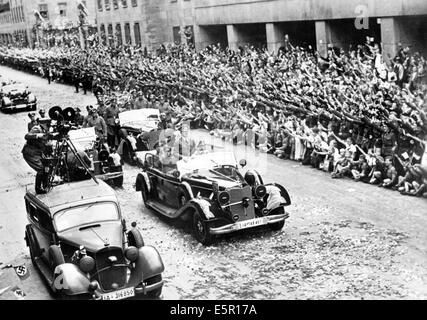 People cheer at Hitler's victory procession outside of the new Reichs ...