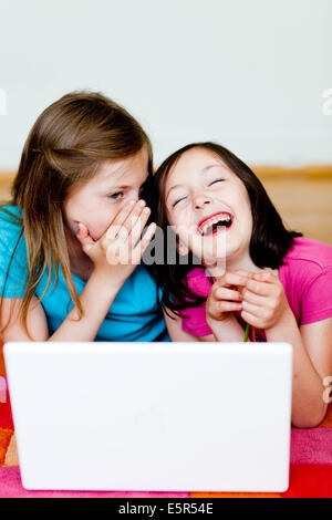7 and 11-year-old sisters using laptop computer Stock Photo - Alamy