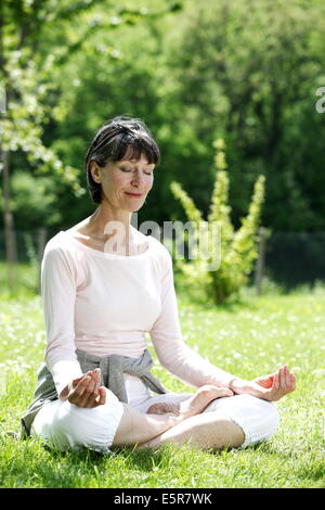 a 70 year old woman yoga instructor in her studio shows Iyengar Yoga ...