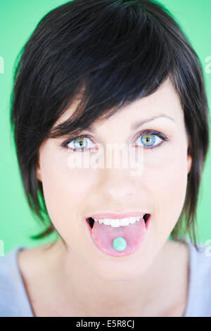 Woman taking lozenge for sorethroat Stock Photo - Alamy