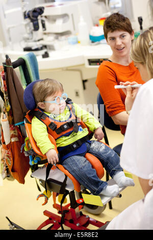 Ophthalmologist examining the interior of the eye of a baby with an ...