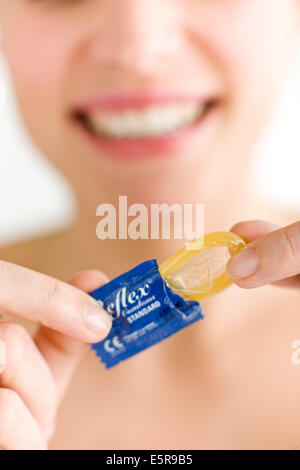 Woman holding a condom Stock Photo - Alamy