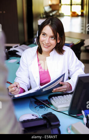 Medical secretary setting appointments in his diary on the phone Stock ...