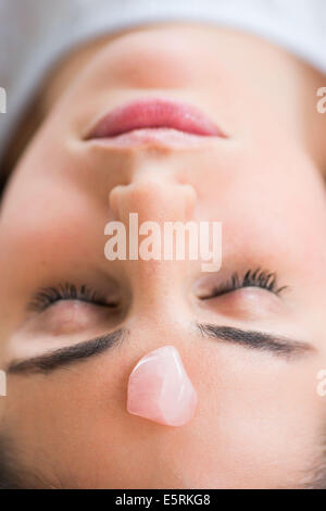 Woman's head with a healing crystal on her forehead Stock Photo - Alamy