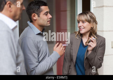 Office workers smoking outside Stock Photo - Alamy