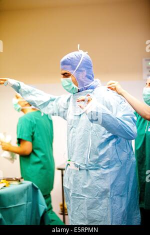 Surgical team getting dressed before surgery, St Antoine hospital ...