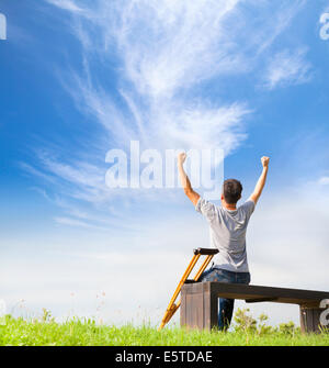 Young man with injured arm sitting on the sofa Stock Photo - Alamy