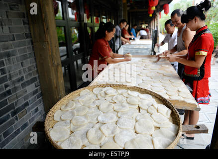 Enshi. 6th Aug, 2014. Girls of Tujia ethnic group make Tujia brocade ...