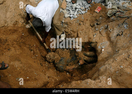 Rescue workers remove a body from the flooding waters near the Toccoa ...