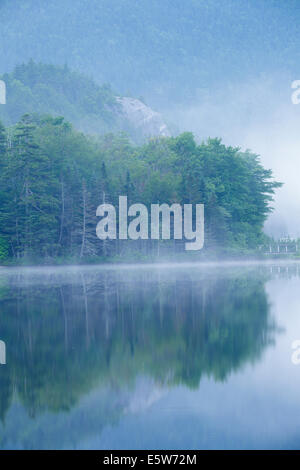 Reflection of Elephant Head rock profile in Saco Lake at the start of ...