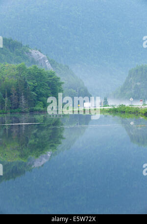Reflection of Elephant Head rock profile in Saco Lake at the start of ...