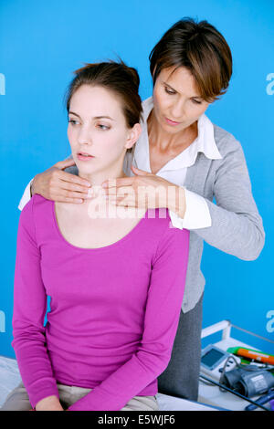 Woman palpation her neck, examine thyroid gland. Enlarged thyroid gland ...