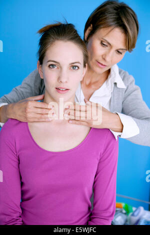 Woman palpation her neck, examine thyroid gland. Enlarged thyroid gland ...