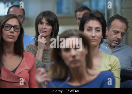 Group of people watching presentation on large screen Stock Photo - Alamy
