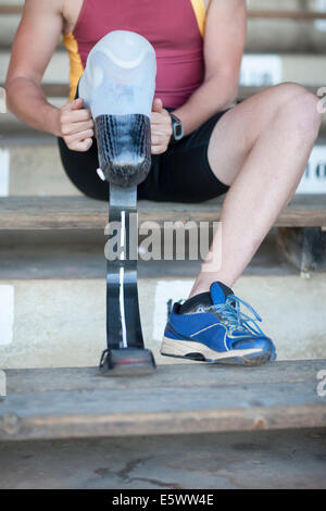 Sprinter sitting with prosthetic leg on Stock Photo - Alamy