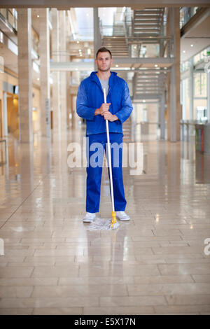 Male cleaner working in the office Stock Photo - Alamy