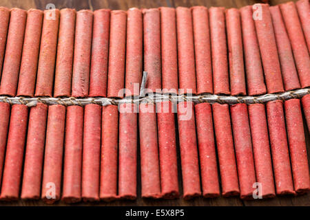 Roll of firecrackers on wood table Stock Photo - Alamy