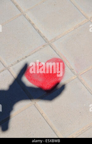 shadow of hand with red heart Stock Photo - Alamy