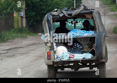 Peddler selling meat on a four-wheel drive, Fioletovo village, Armenia ...