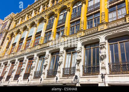 nice old building with highly decorated facade and large windows in ...
