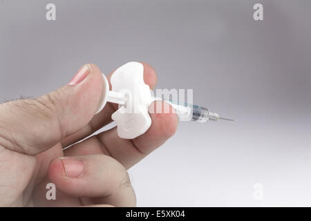 Hand with a syringe in position to inject Stock Photo - Alamy