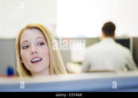 Office worker peering over cubicle wall Stock Photo - Alamy