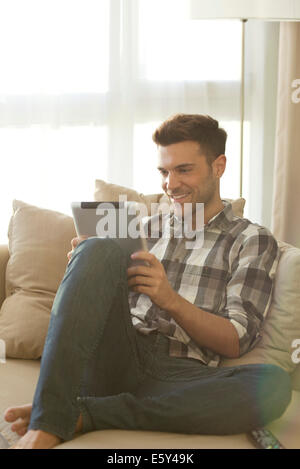 Young man staying late in office to do overtime work Stock Photo - Alamy