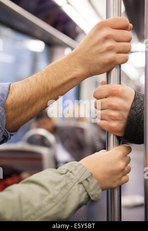A shot of hand holds on a subway car Stock Photo - Alamy