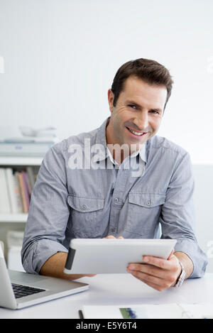 Smiling interior designers using digital tablet Stock Photo - Alamy