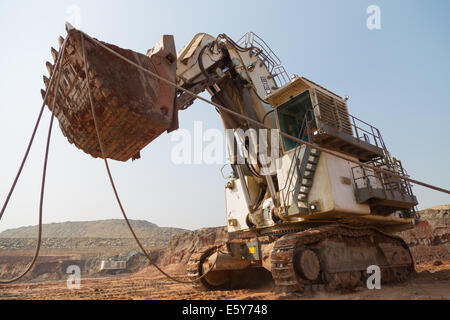 A massive Liebherr face shovel excavator loads overburden soil in a ...