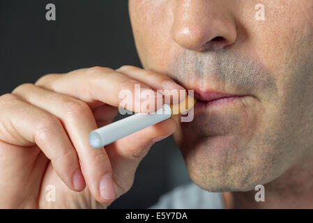 Cropped close up man smoking cigarette outdoors shot Stock Photo - Alamy
