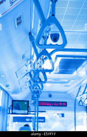 Handles for standing passenger inside a bus Stock Photo - Alamy
