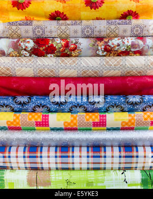 Stack of folded colorful fabrics Stock Photo - Alamy