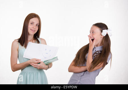 Teacher checking notebooks students saw one of them funny painted a ...