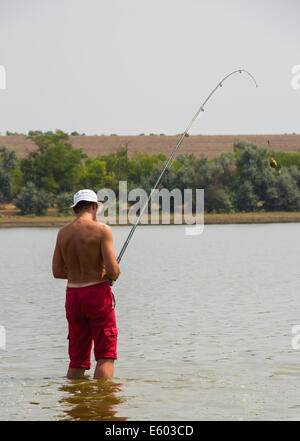 fisherman on the river or a pond for fishing Stock Photo - Alamy