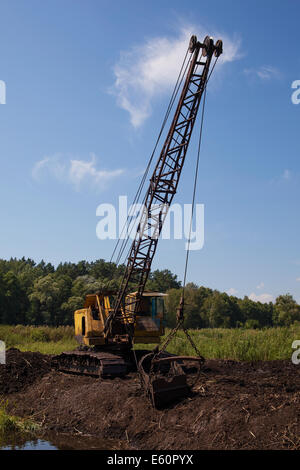 Old dragline (excavator) on the peat quarry in the swamp Stock Photo ...
